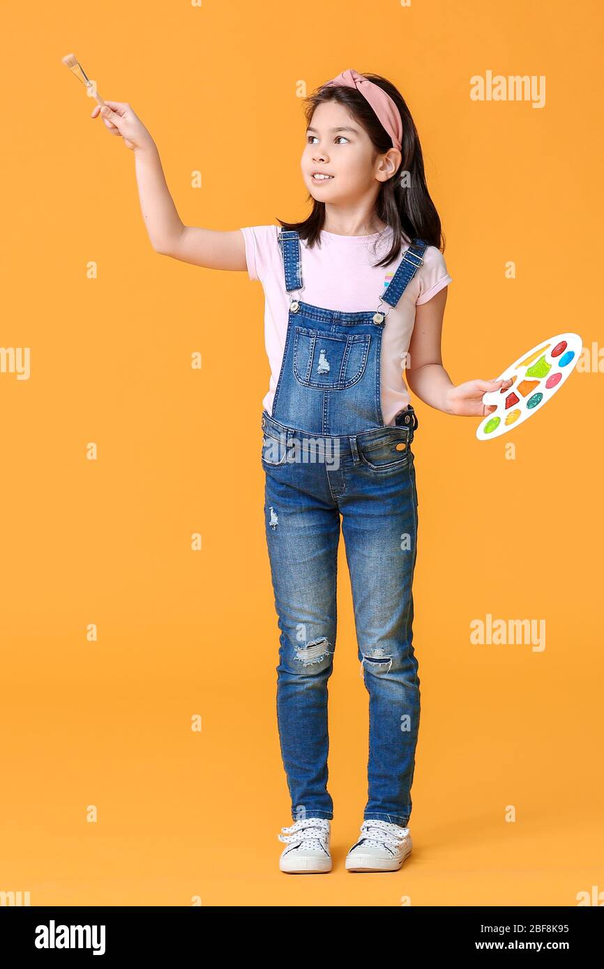 Cute little artist on color background Stock Photo - Alamy