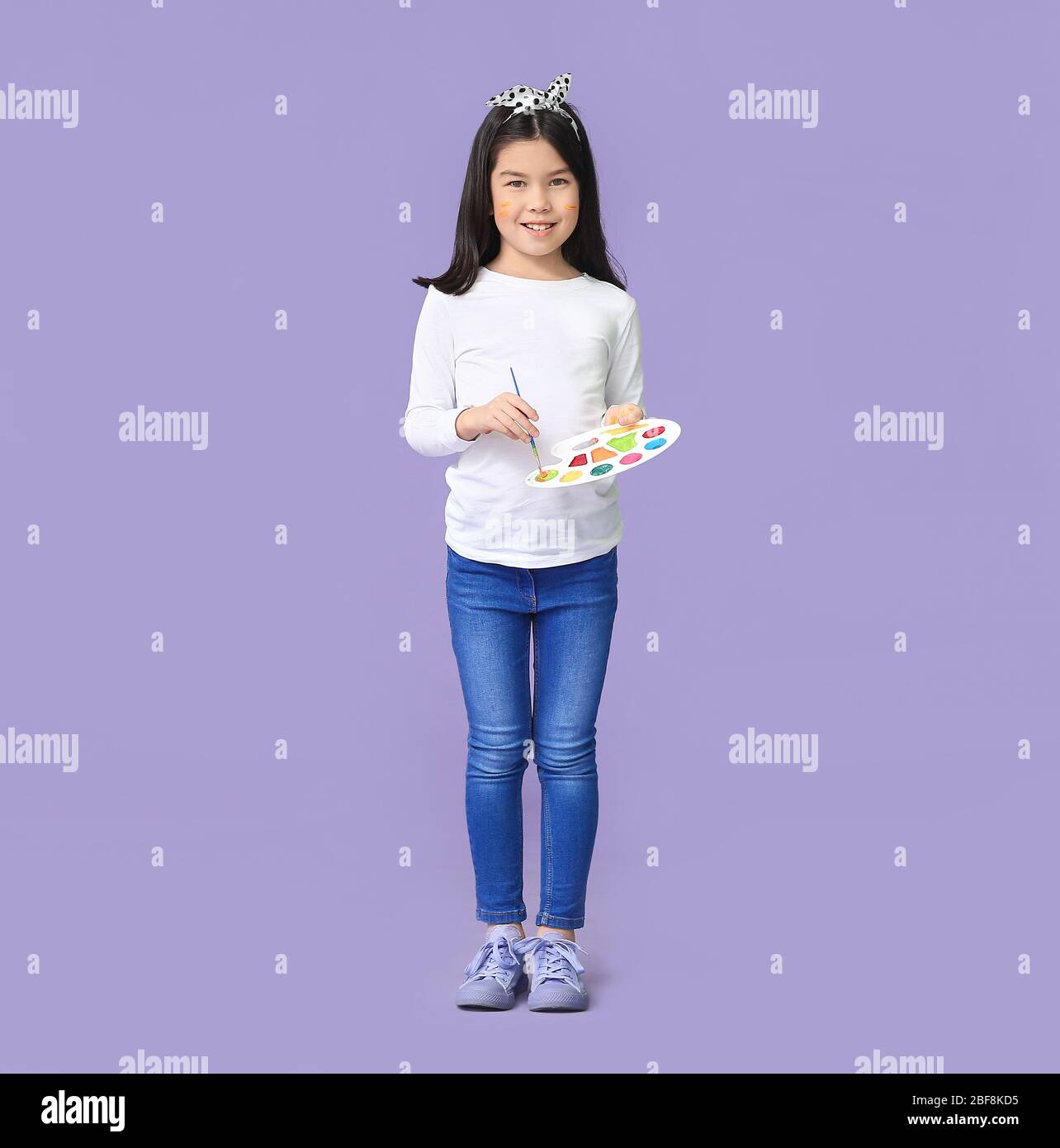 Cute little artist on color background Stock Photo - Alamy