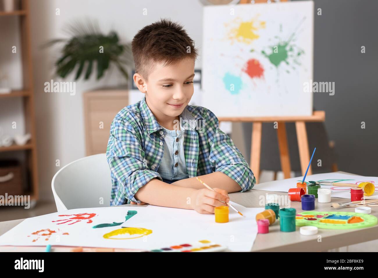 Cute little boy painting at home Stock Photo - Alamy