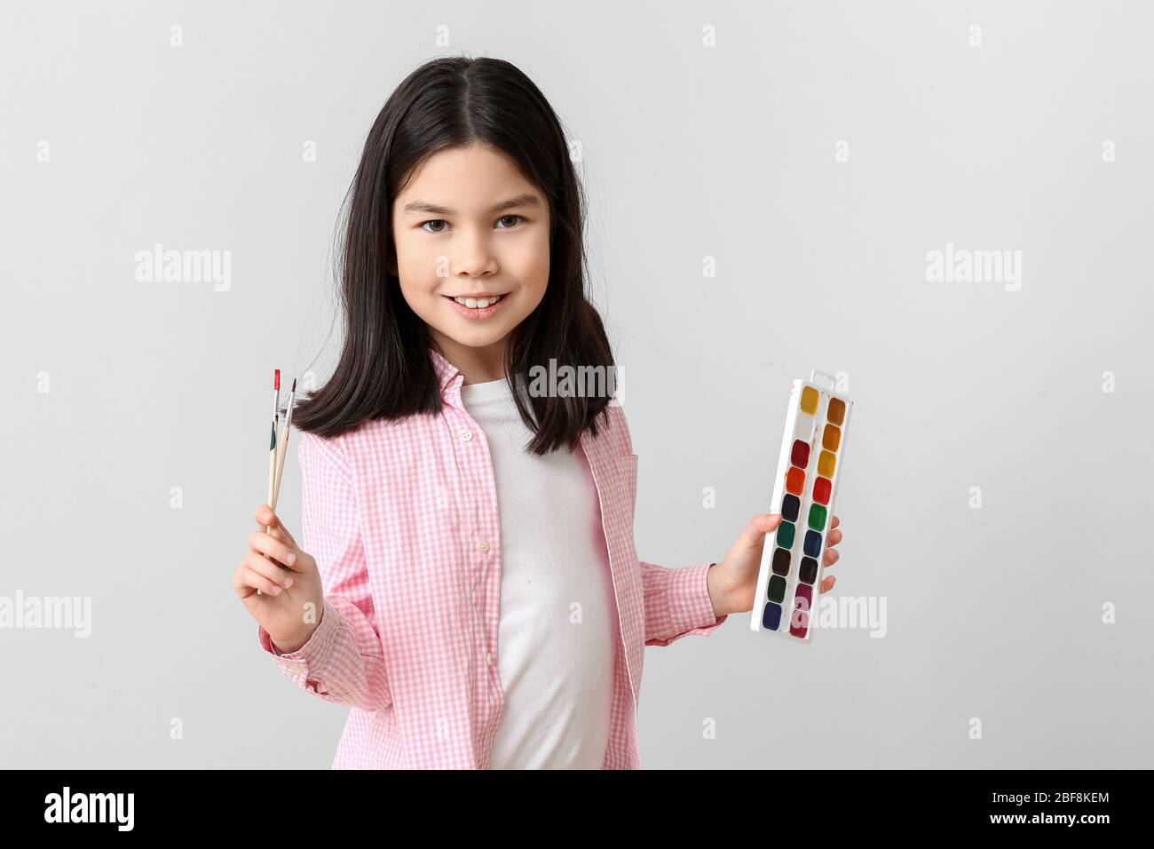 Cute little artist on light background Stock Photo - Alamy