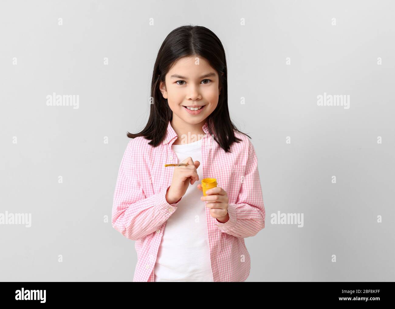 Cute little artist on light background Stock Photo - Alamy