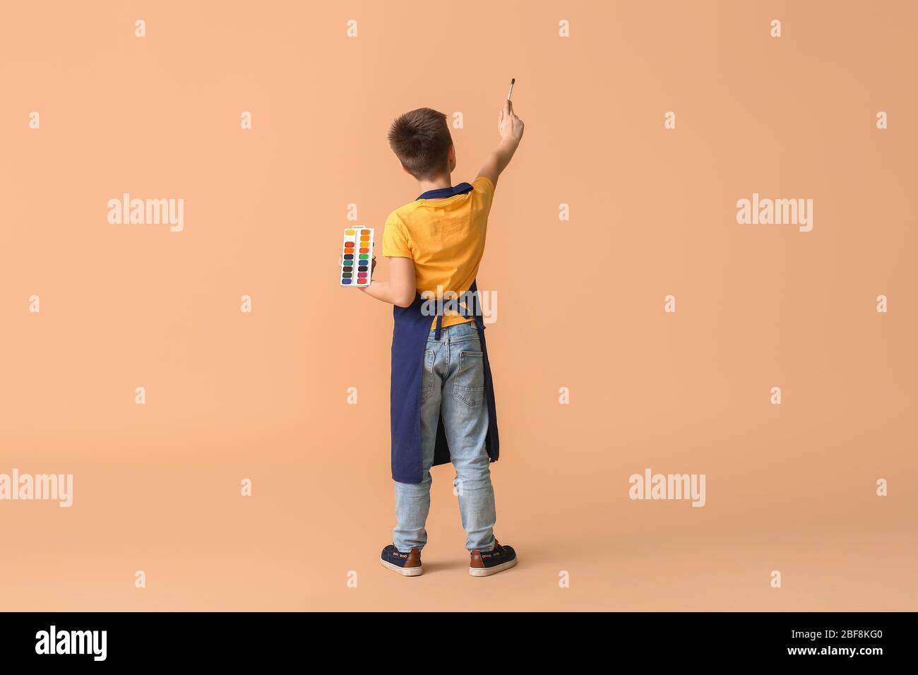 Cute little artist on color background Stock Photo - Alamy