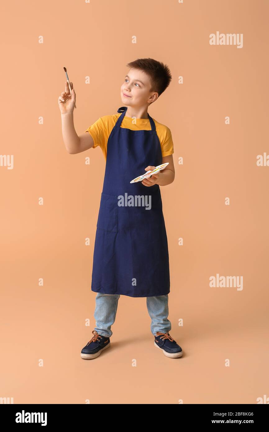 Cute little artist on color background Stock Photo - Alamy