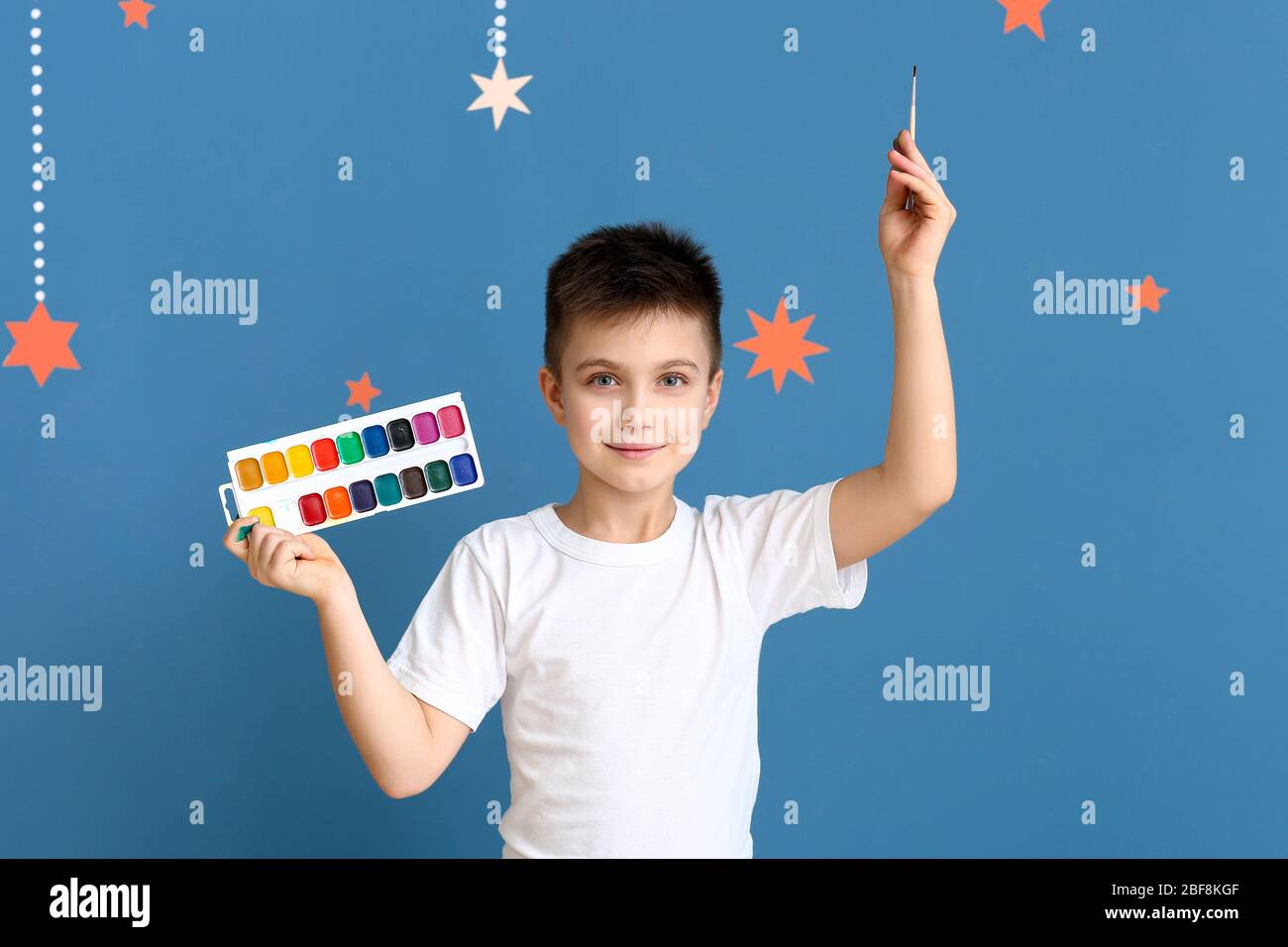 Cute little artist on color background Stock Photo - Alamy