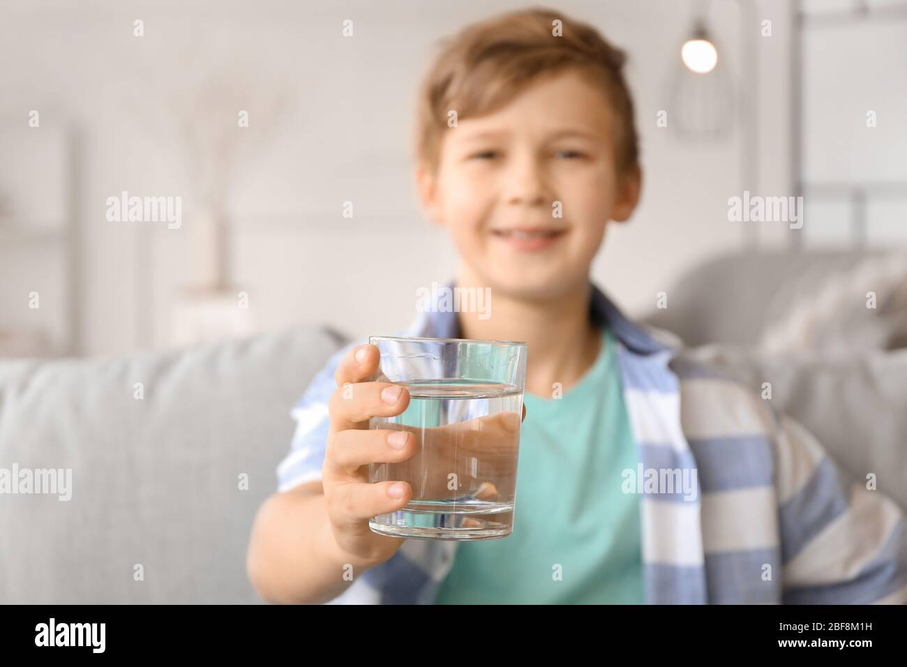 Cute little boy drinking water at home Stock Photo - Alamy