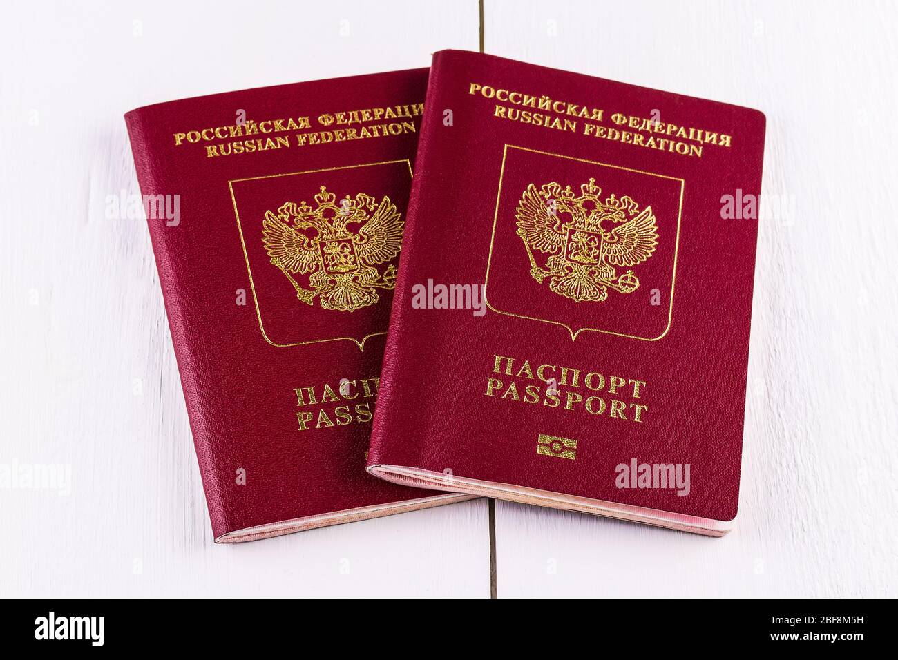 Two foreign biometric passports of the Russian Federation on a white ...