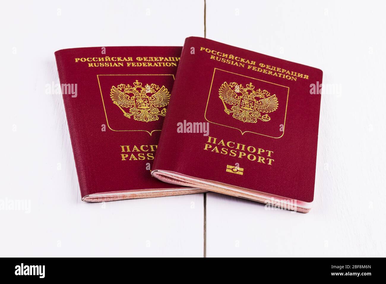 Two foreign biometric passports of the Russian Federation on a white ...