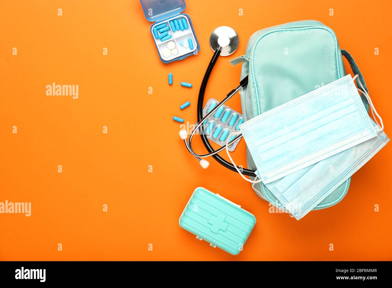 First aid kit on color background Stock Photo - Alamy