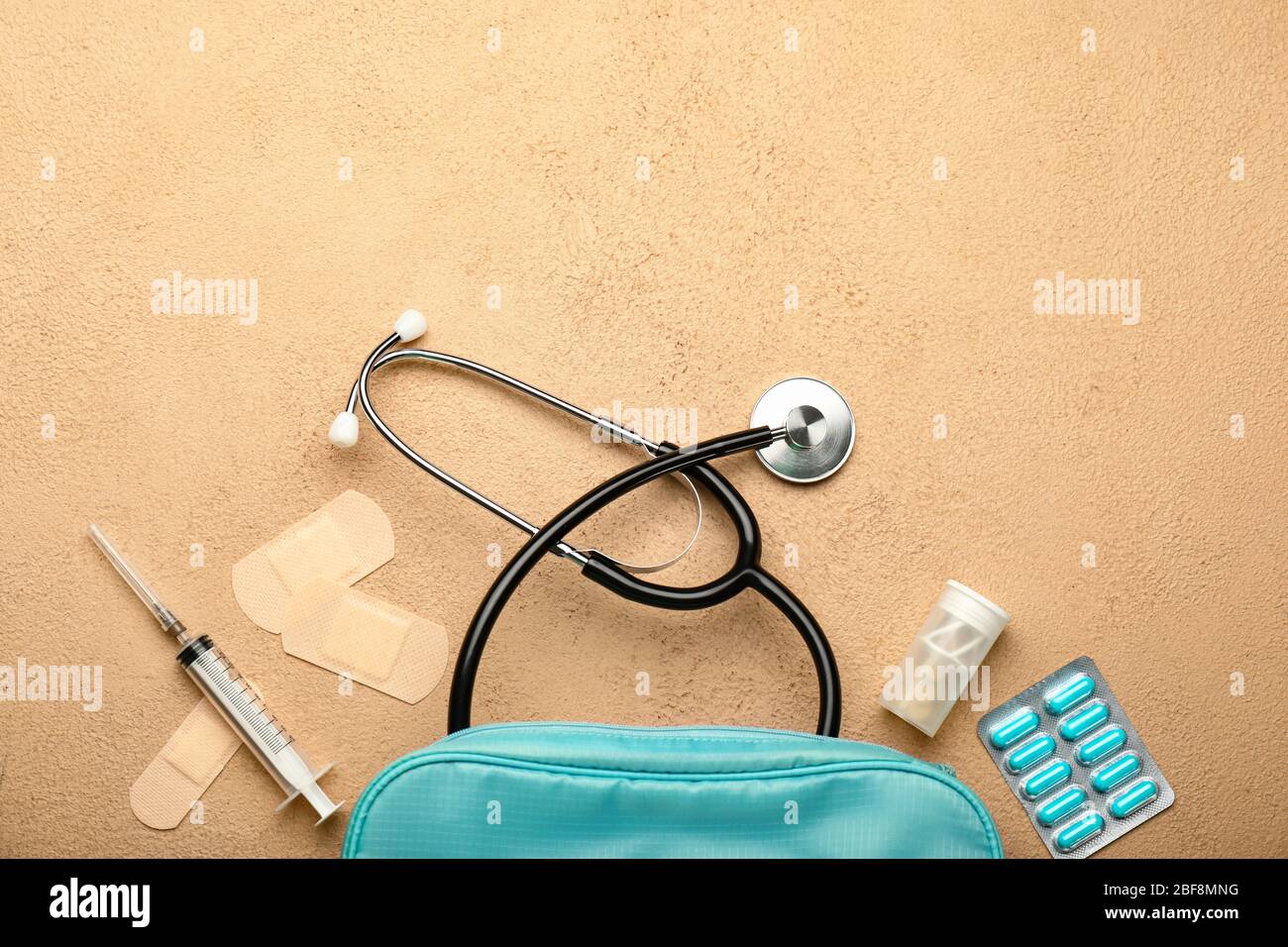 First aid kit on color background Stock Photo - Alamy