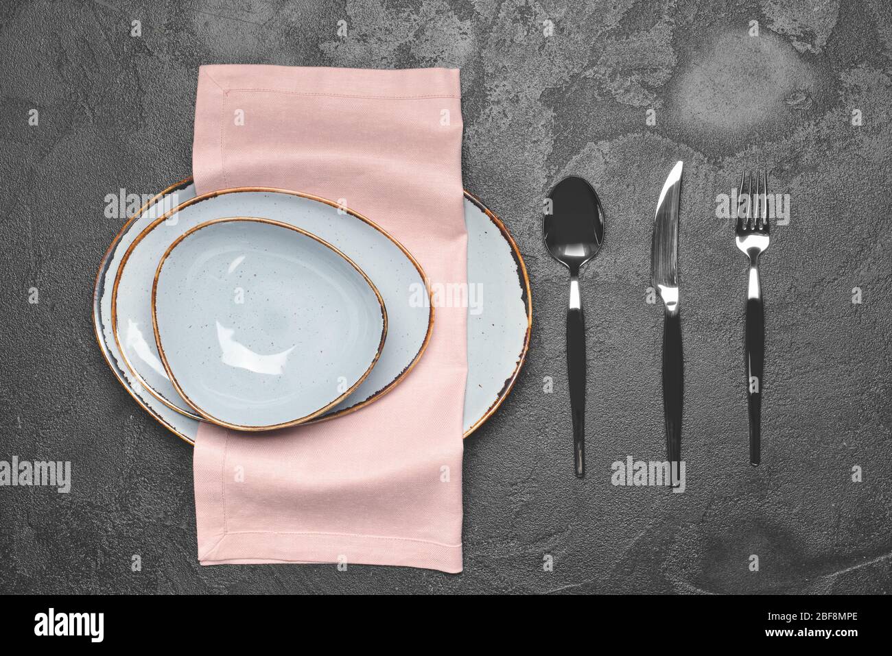 Simple table setting on dark background Stock Photo - Alamy