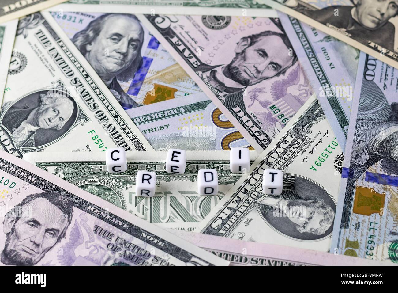 American dollar bills background and the word credit laid out of cubes ...
