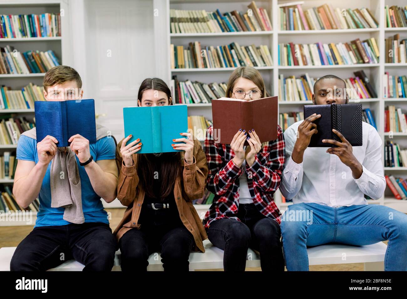 Boy hiding behind shelf hi-res stock photography and images - Alamy