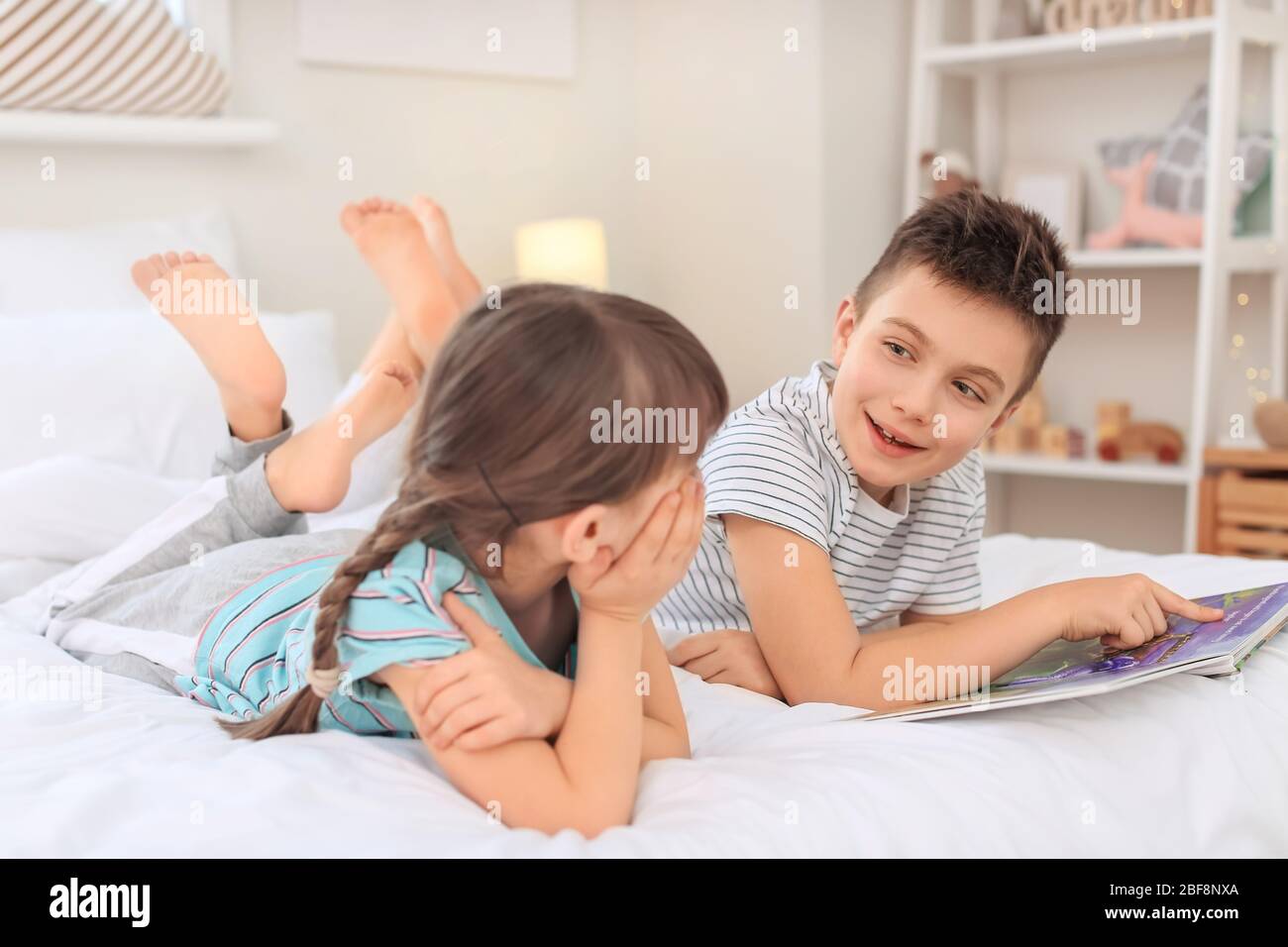 Little children reading bedtime story at home Stock Photo - Alamy