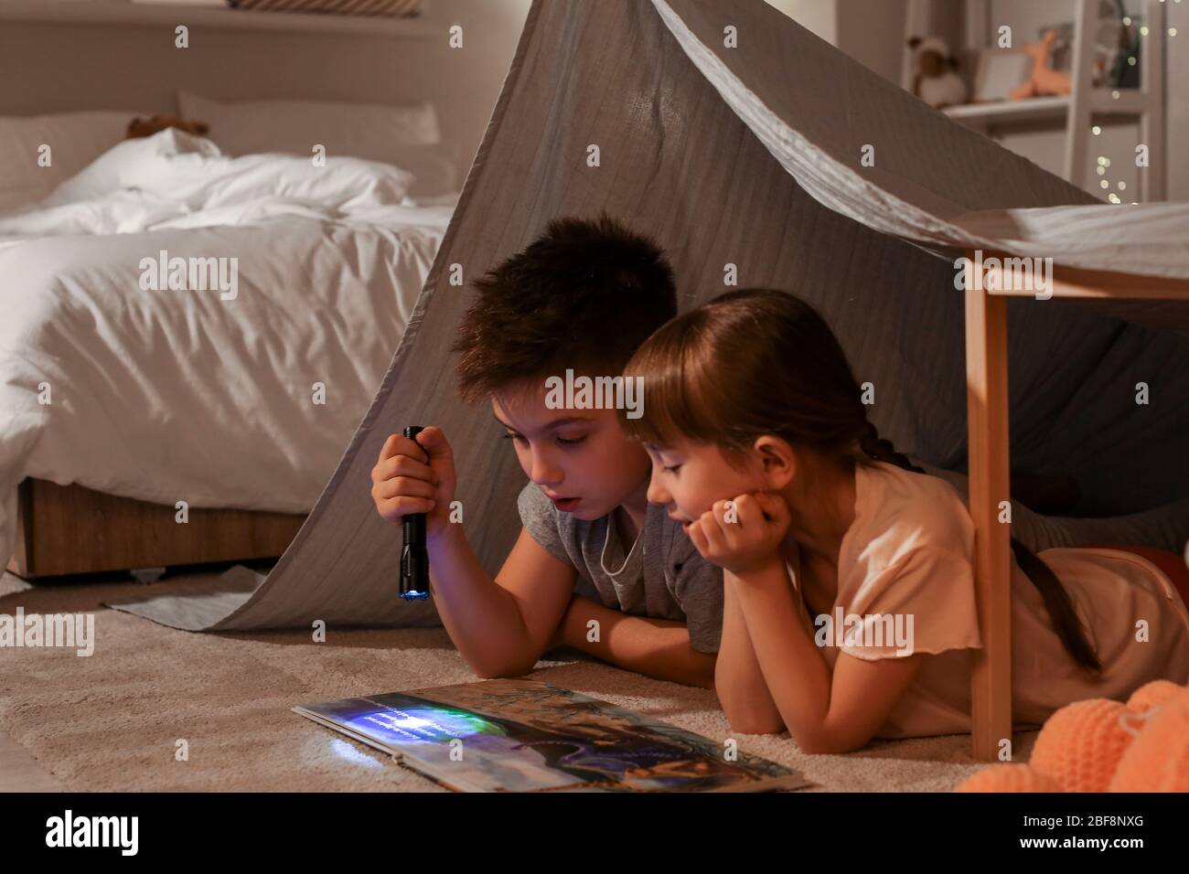 Little children reading bedtime story at home Stock Photo - Alamy