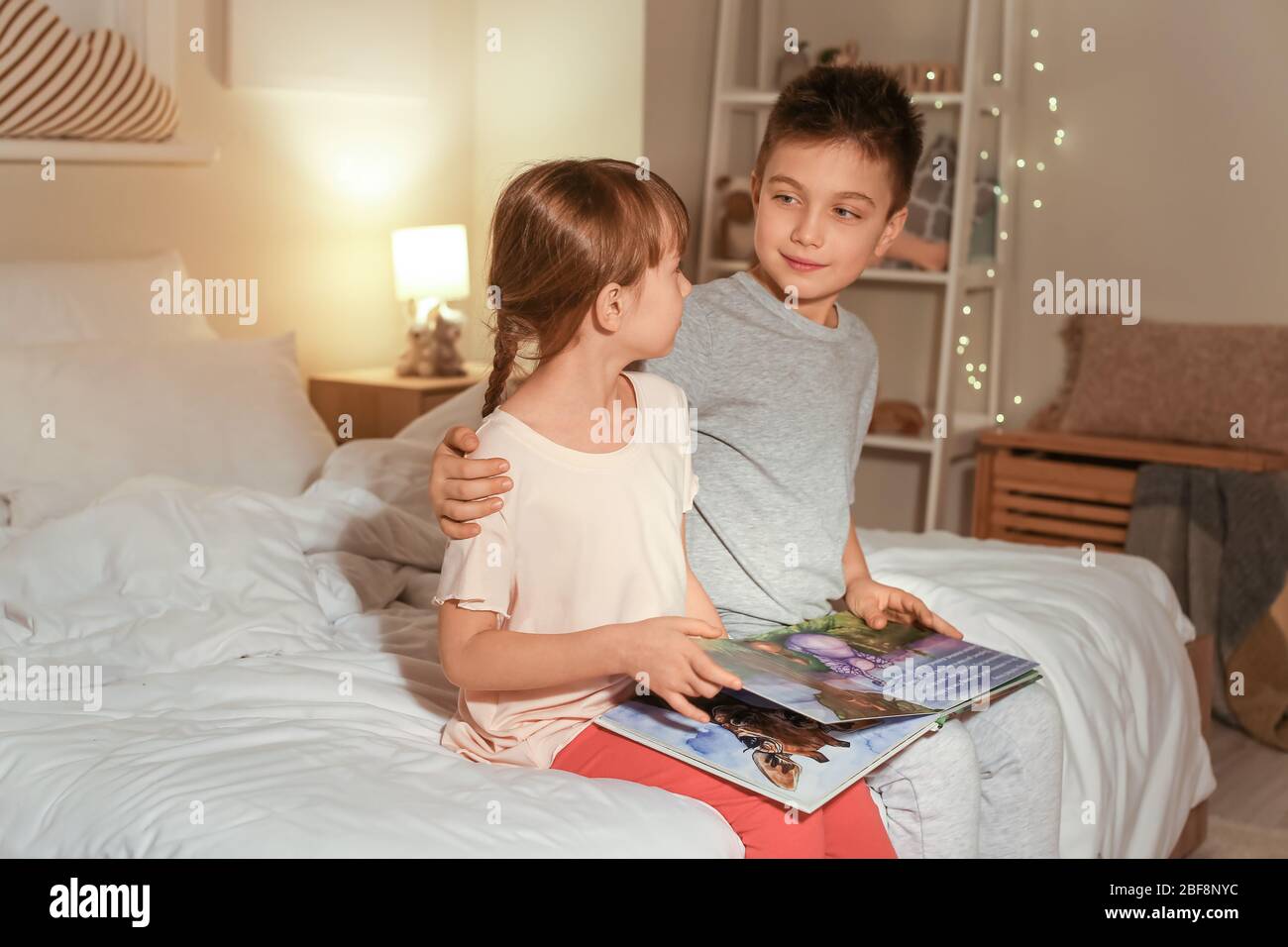 Little children reading bedtime story at home Stock Photo - Alamy