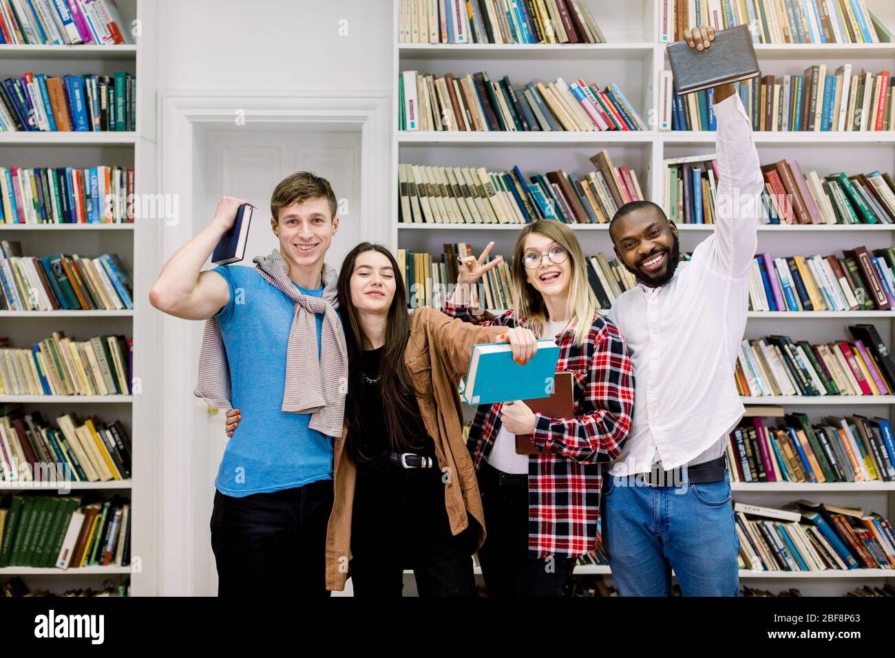 Students in library, happy learning and education. Young people with ...