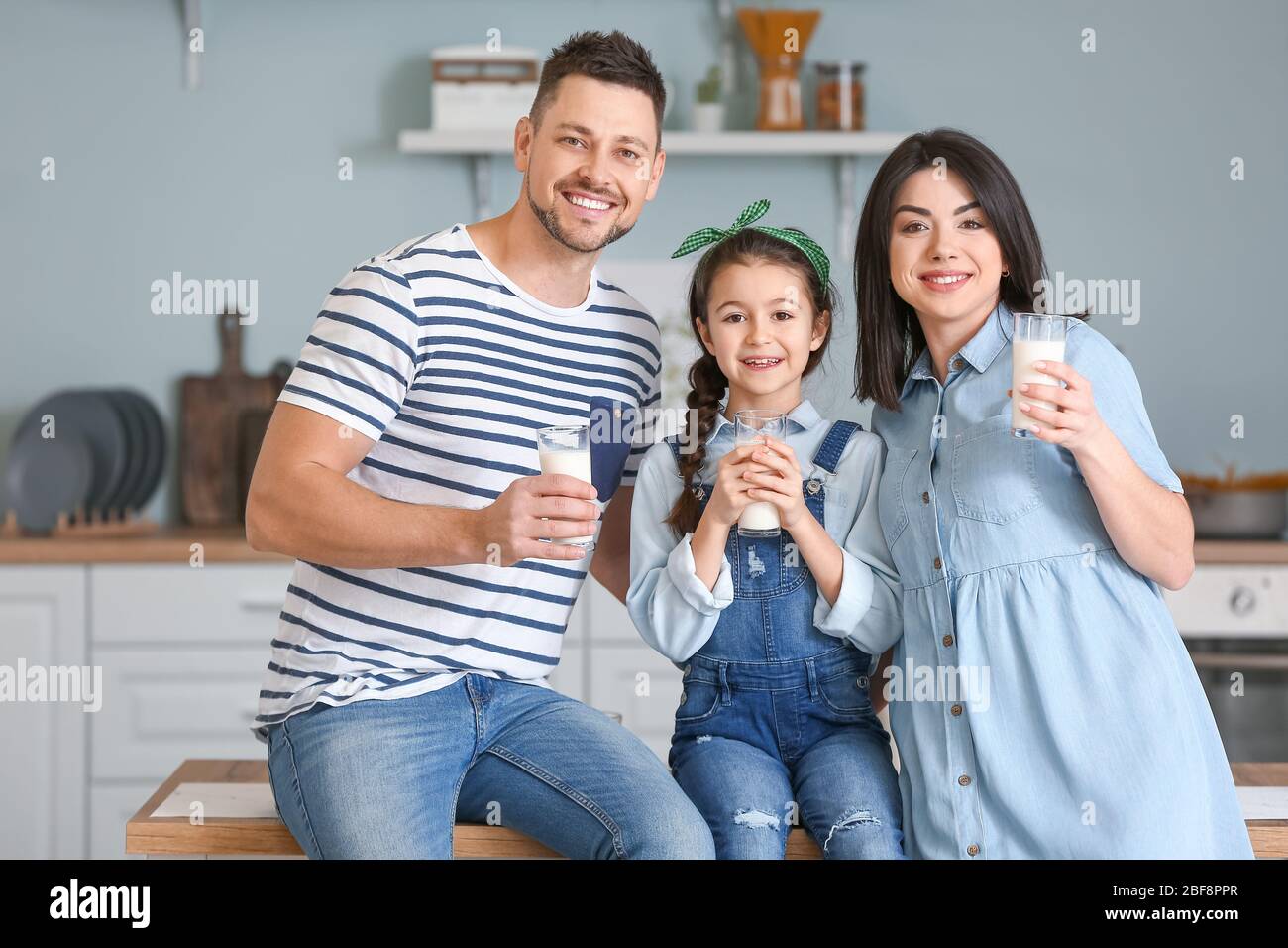 Family drinking milk at home Stock Photo - Alamy