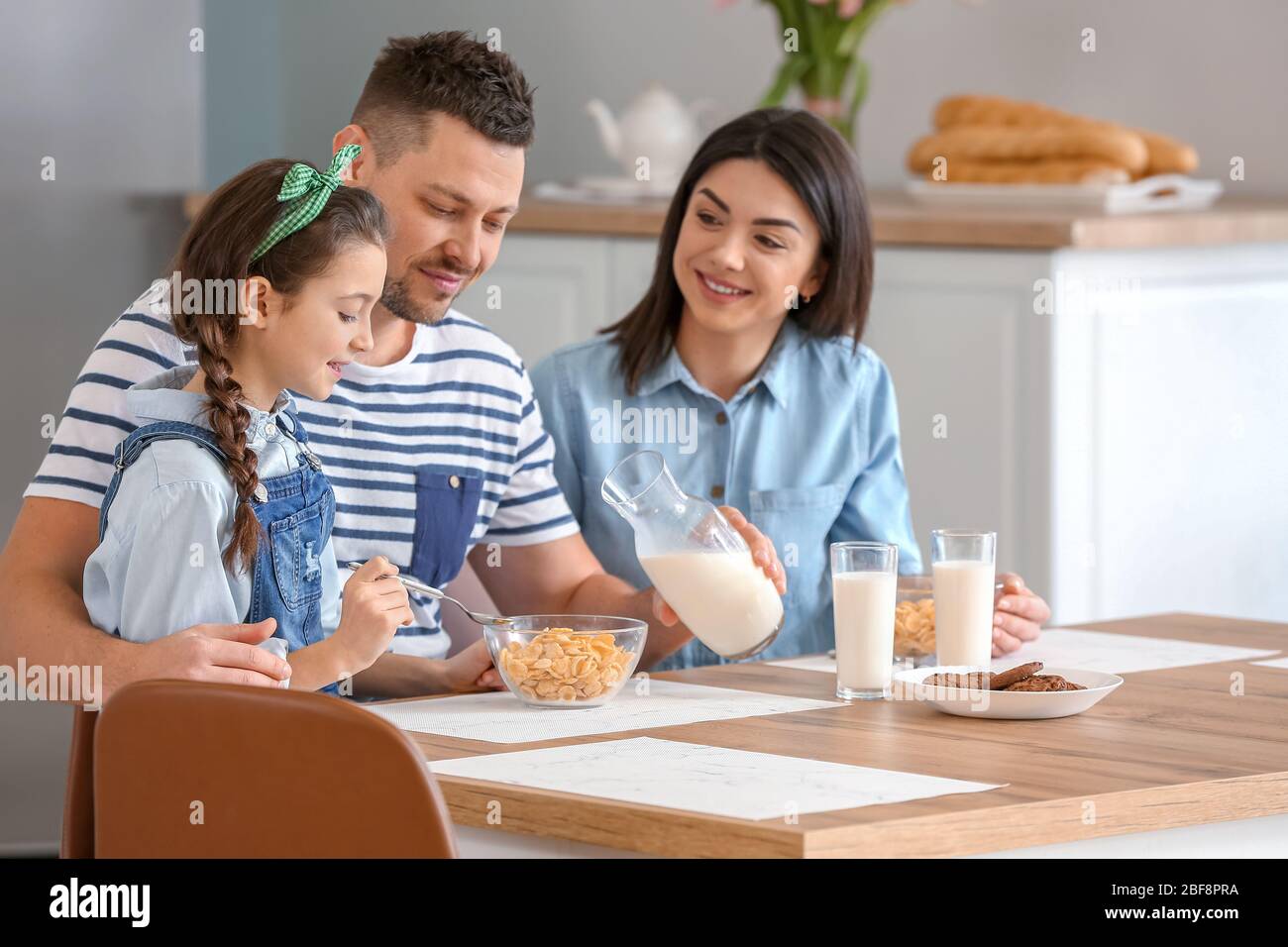 Family drinking milk during breakfast at home Stock Photo - Alamy
