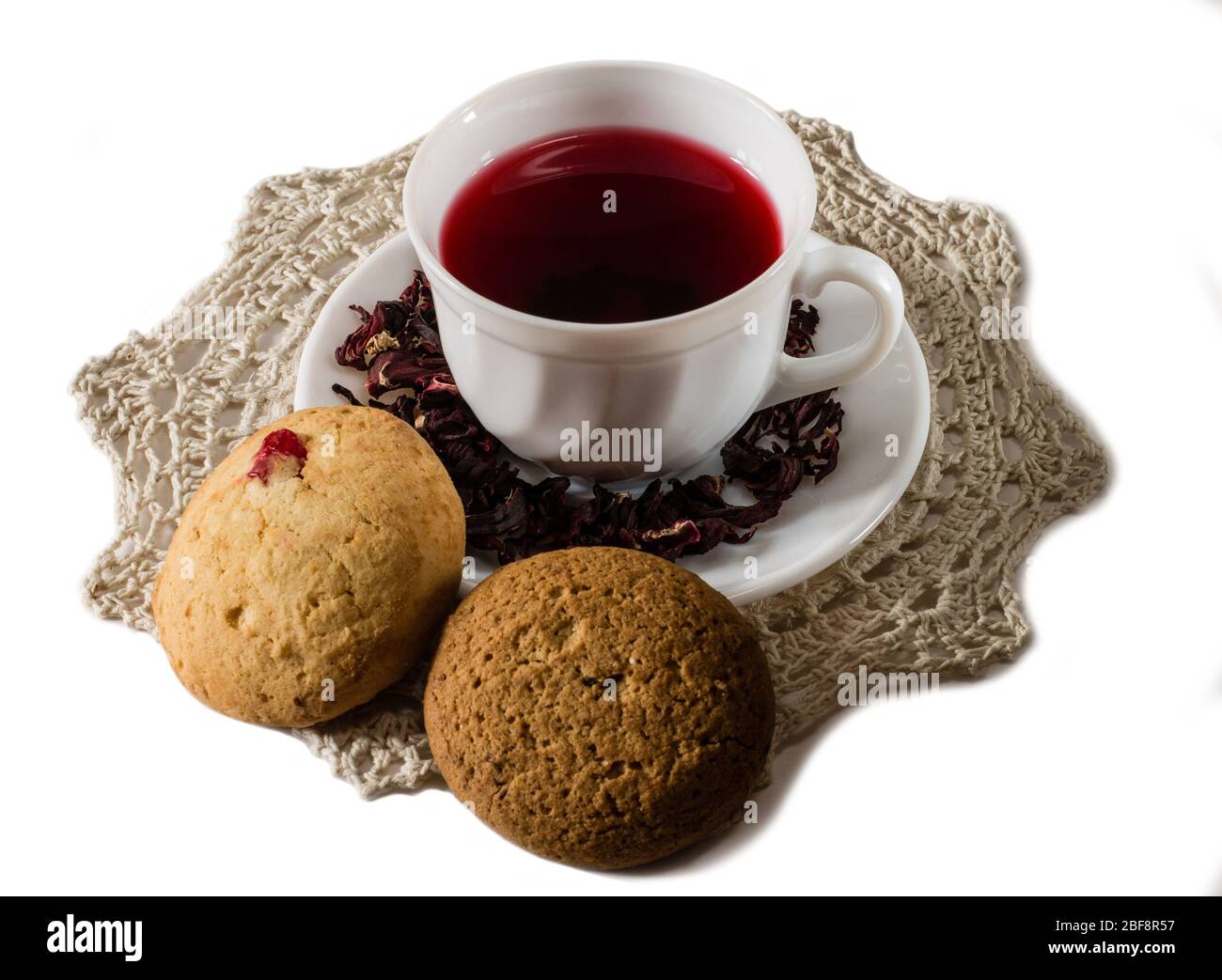 Cup of Karkadeh Red Tea with Dry Flowers and cookies isolated on a ...