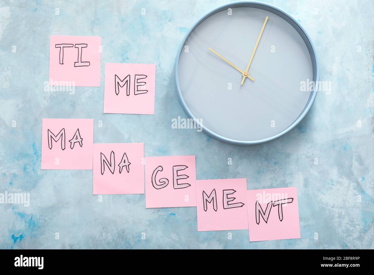 Clock and text TIME MANAGEMENT on color background Stock Photo - Alamy