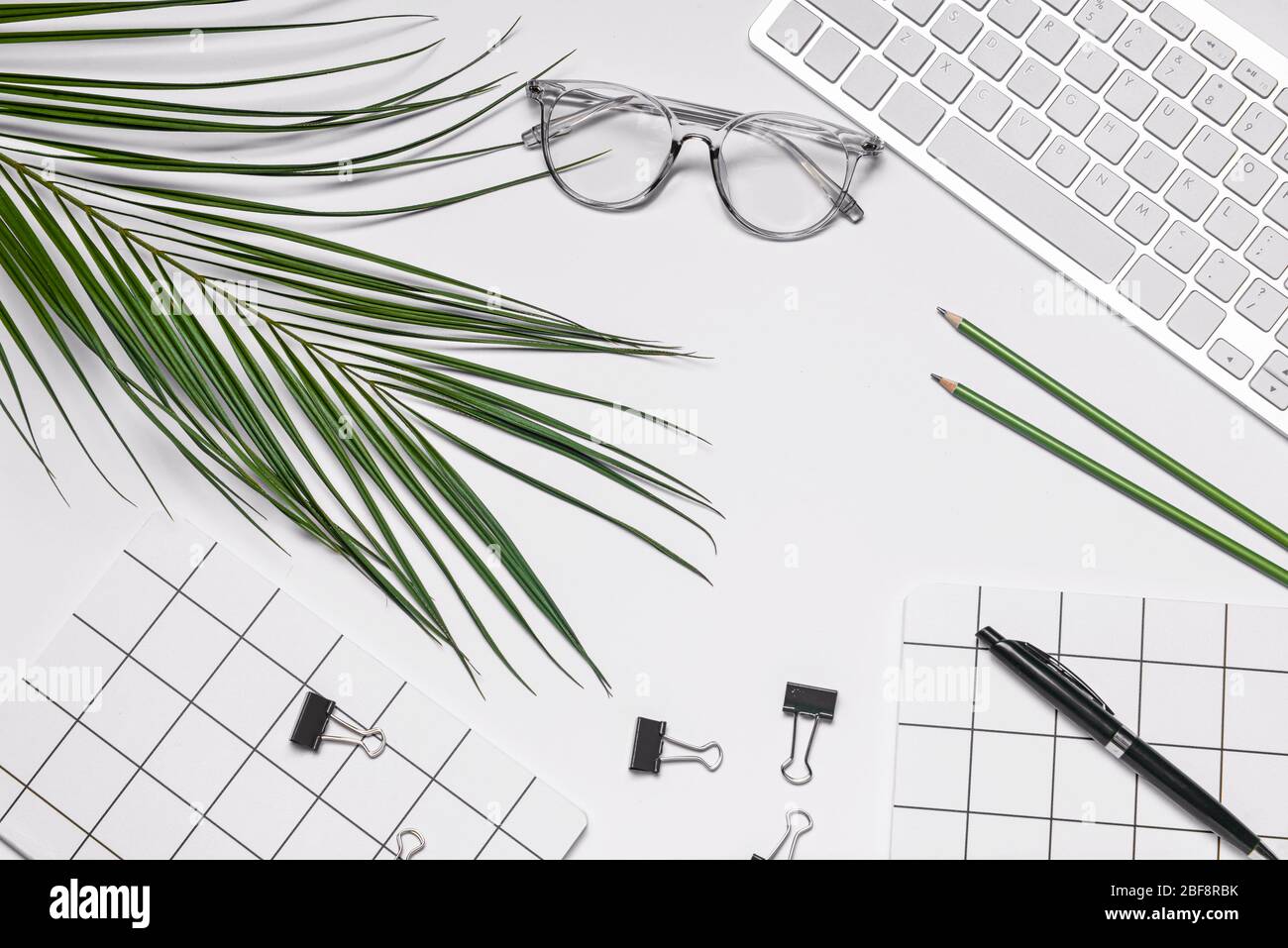 Set of school supplies with computer keyboard and eyeglasses on white ...