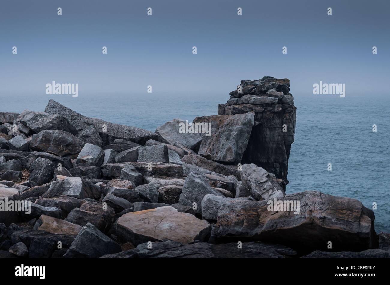 Cliff top view of the jurassic coast cliffs during foggy weather at ...