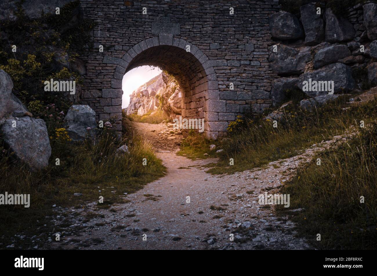 The old quarry bridge with golden sunlight shining through at Tout ...