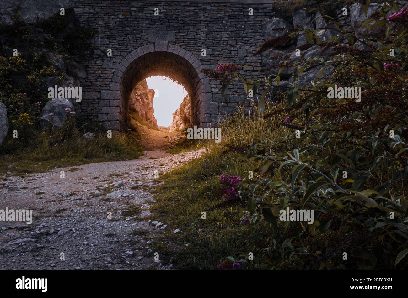 The old quarry bridge with golden sunlight shining through at Tout ...