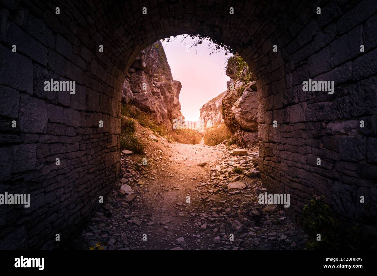 The old quarry bridge with golden sunlight shining through at Tout ...