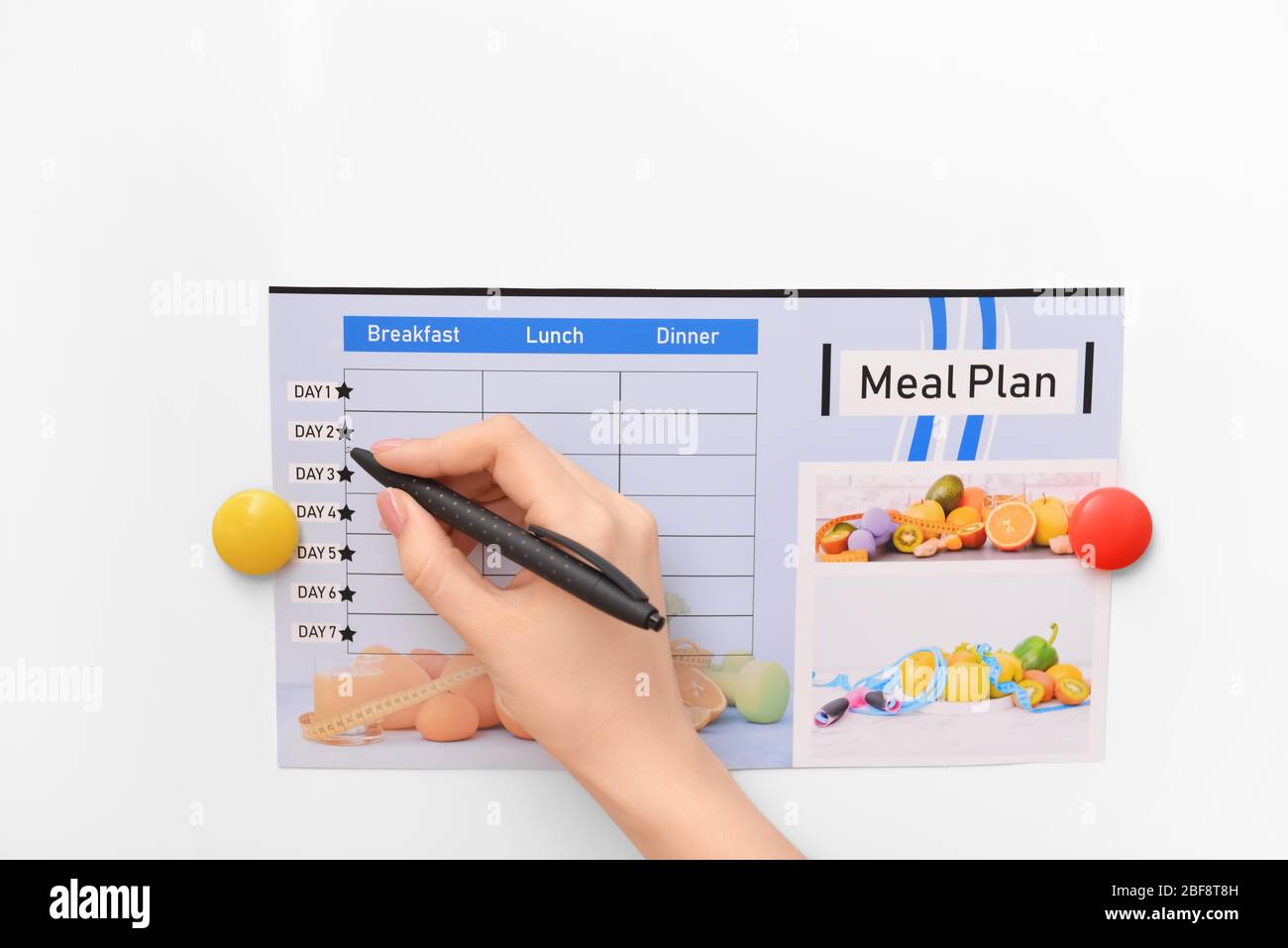 Woman making meal plan on white background Stock Photo - Alamy