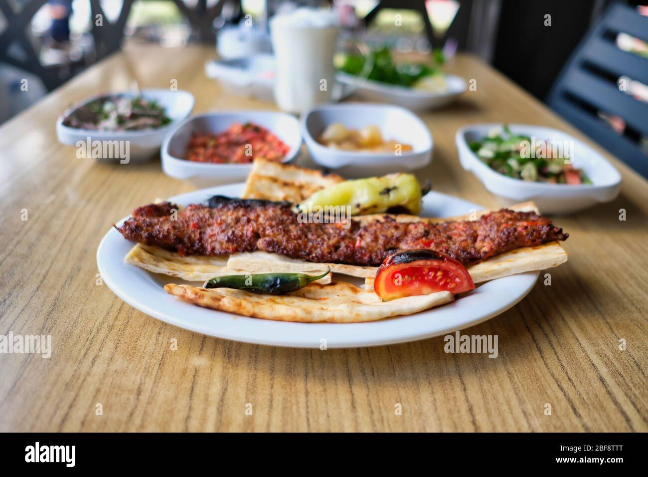 Kebab or kebap on metal skewer barbecue in the kebap restaurant ...