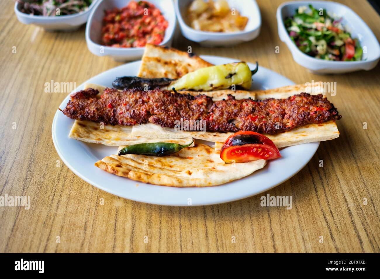 Kebab or kebap on metal skewer barbecue in the kebap restaurant ...