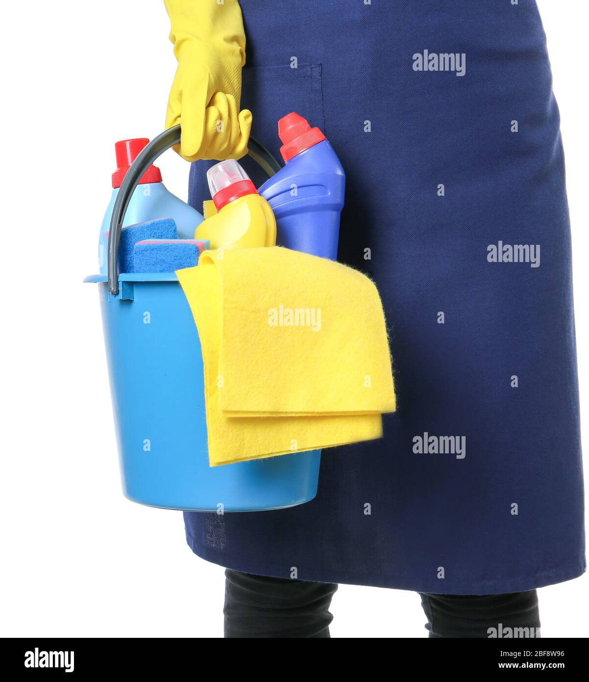 Female janitor with cleaning supplies in bucket on white background ...