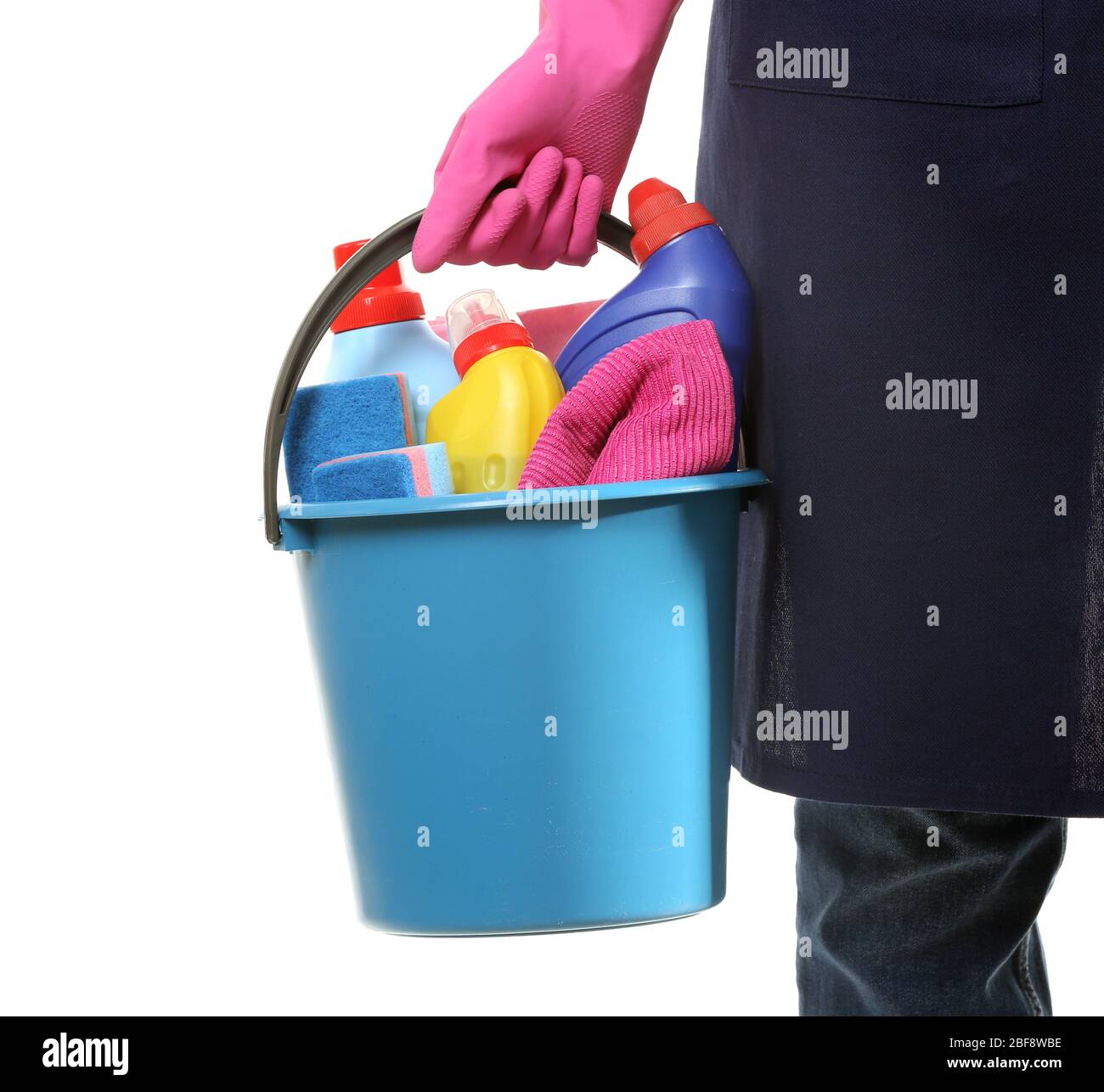 Female janitor with cleaning supplies in bucket on white background ...