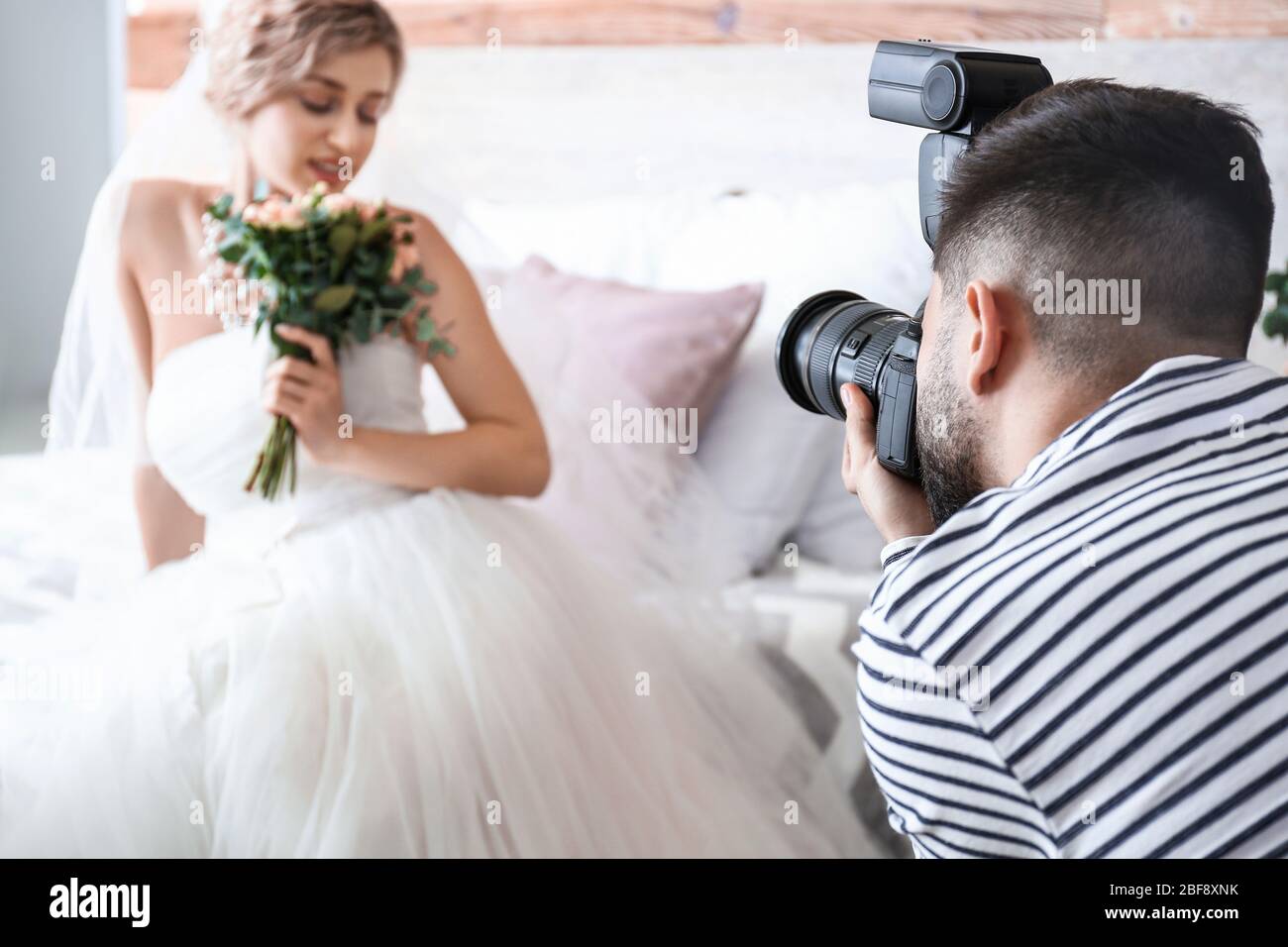 Photographer working with young bride in studio Stock Photo - Alamy