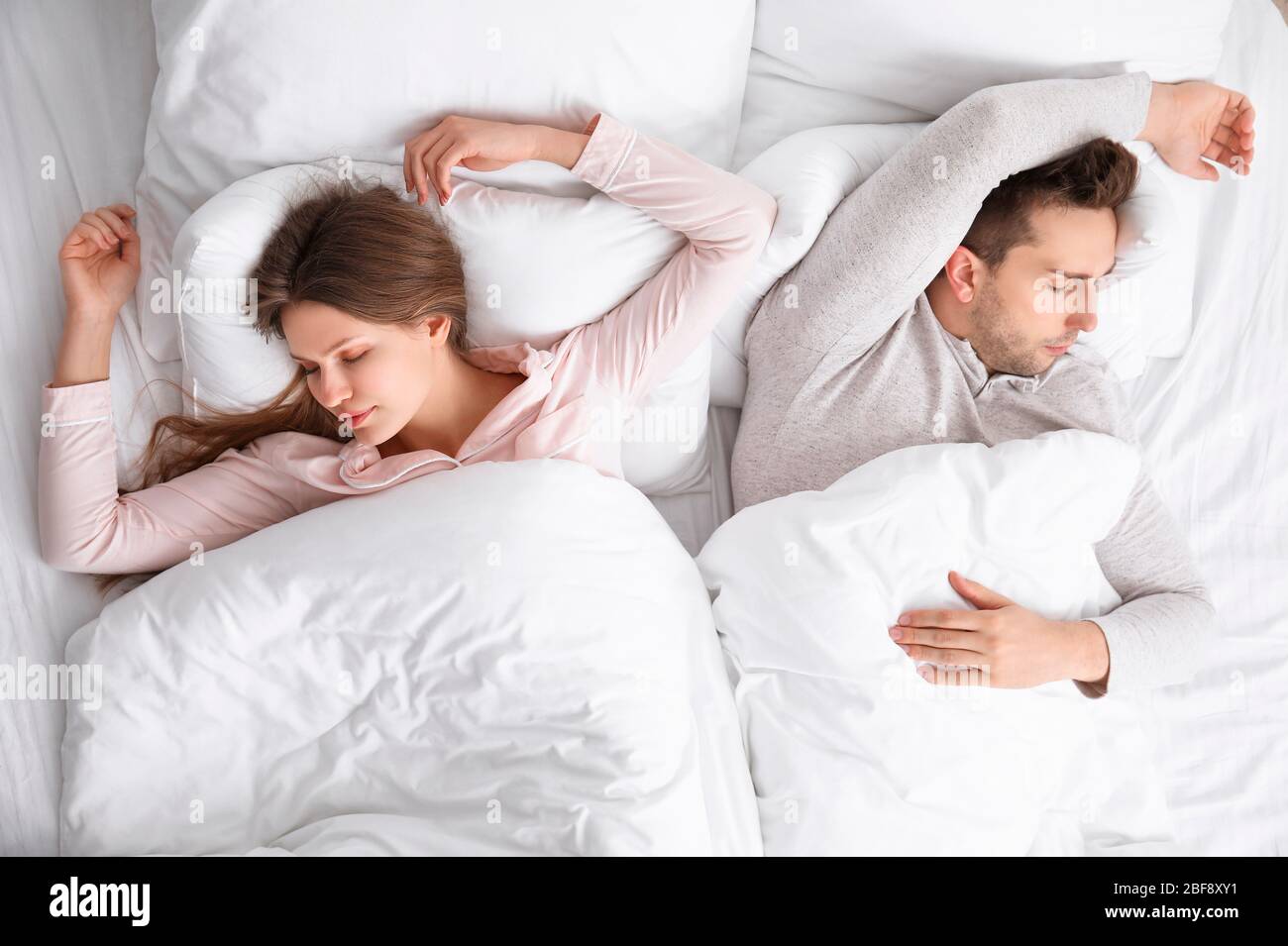 Young couple sleeping in bed Stock Photo - Alamy