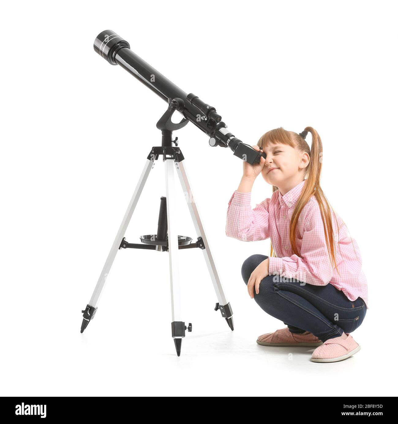 Cute little girl with telescope on white background Stock Photo - Alamy