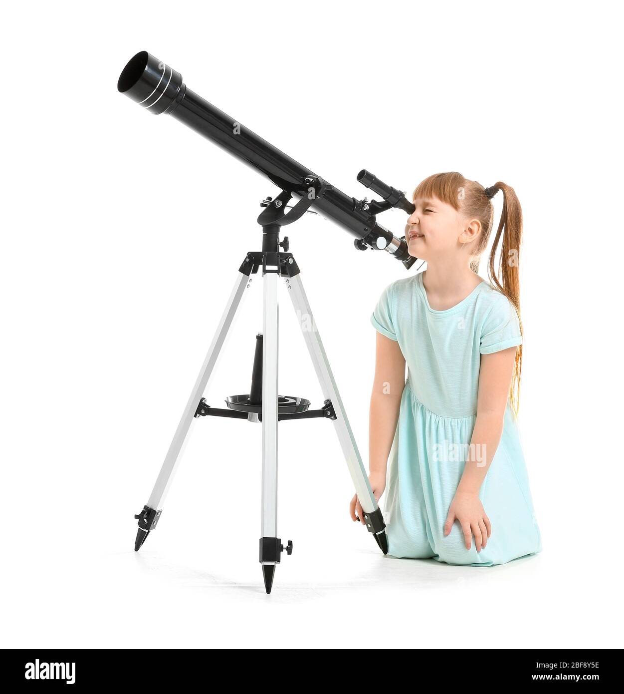 Cute little girl with telescope on white background Stock Photo - Alamy