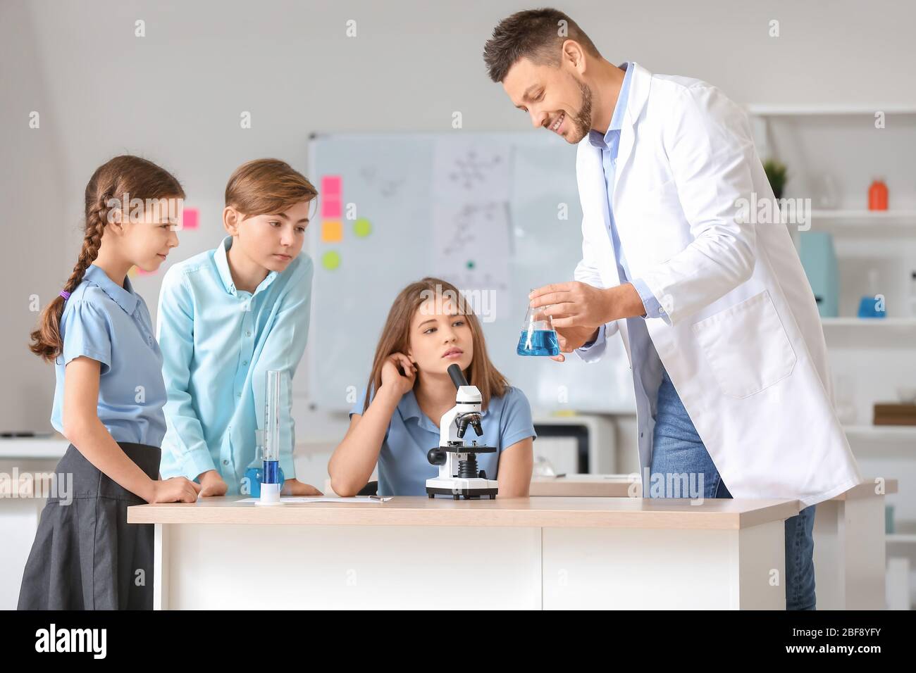 Teacher conducting chemistry lesson in classroom Stock Photo - Alamy