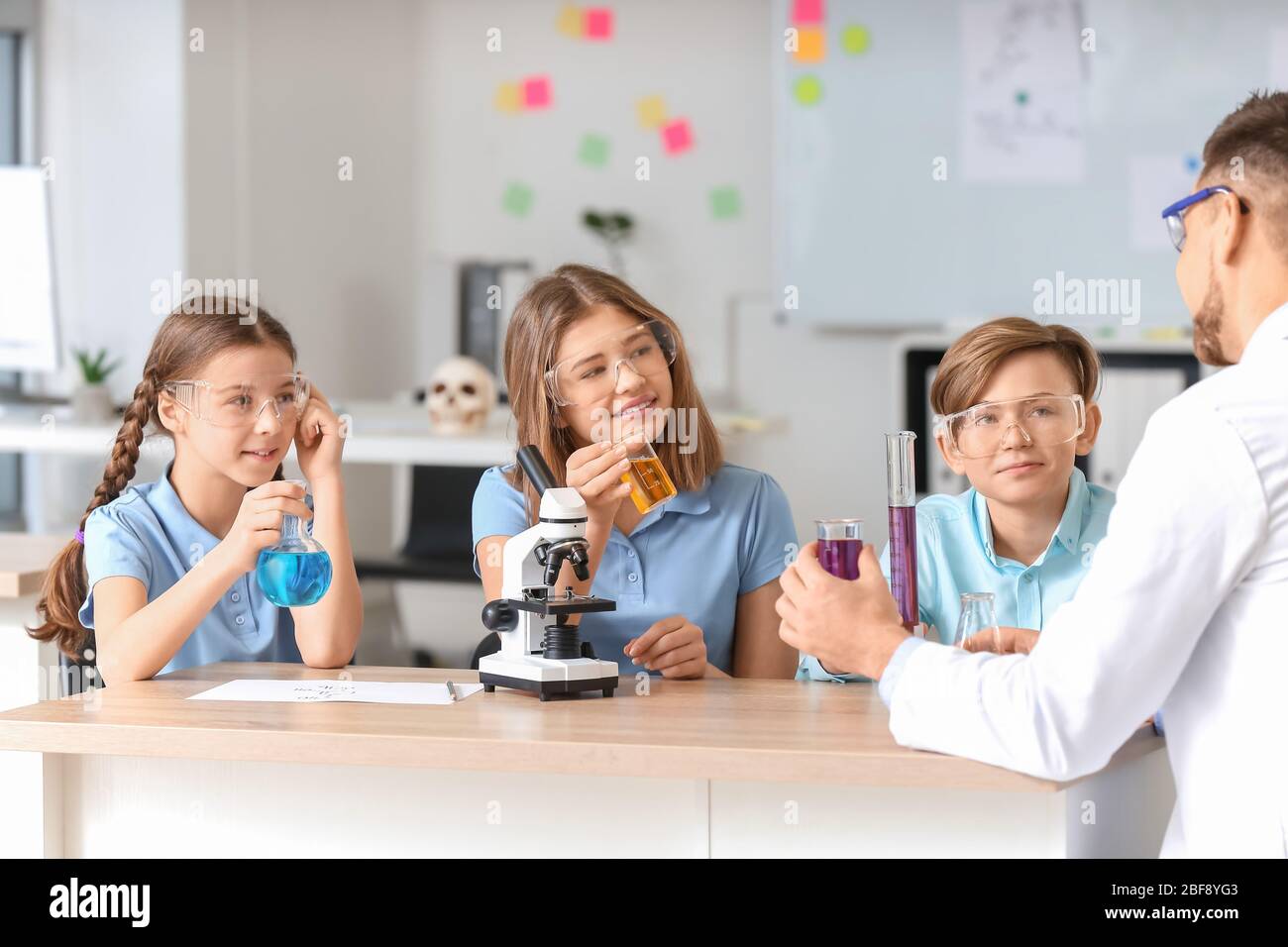 Teacher conducting chemistry lesson in classroom Stock Photo - Alamy