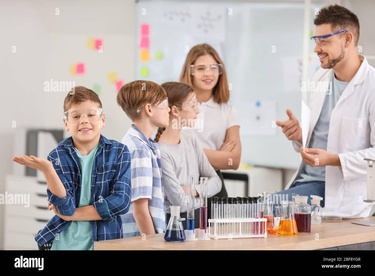 Teacher conducting chemistry lesson in classroom Stock Photo - Alamy