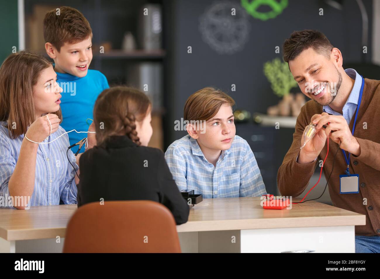 Teacher conducting physics lesson in classroom Stock Photo - Alamy