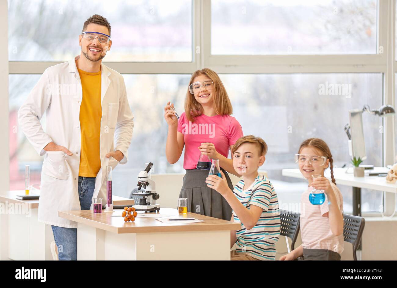 Teacher conducting chemistry lesson in classroom Stock Photo - Alamy