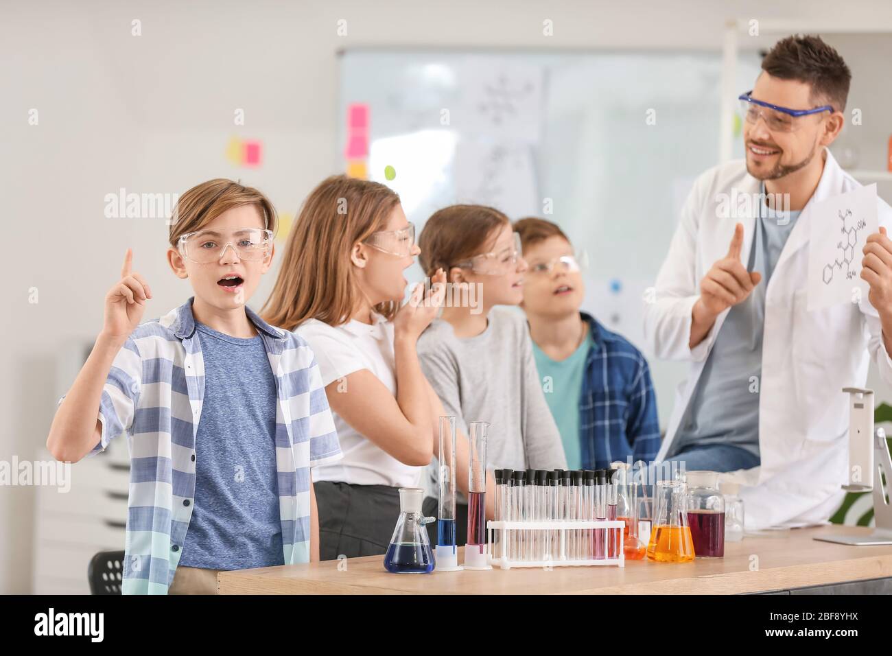 Teacher conducting chemistry lesson in classroom Stock Photo - Alamy