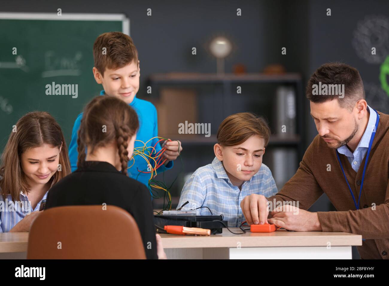 Teacher conducting physics lesson in classroom Stock Photo - Alamy