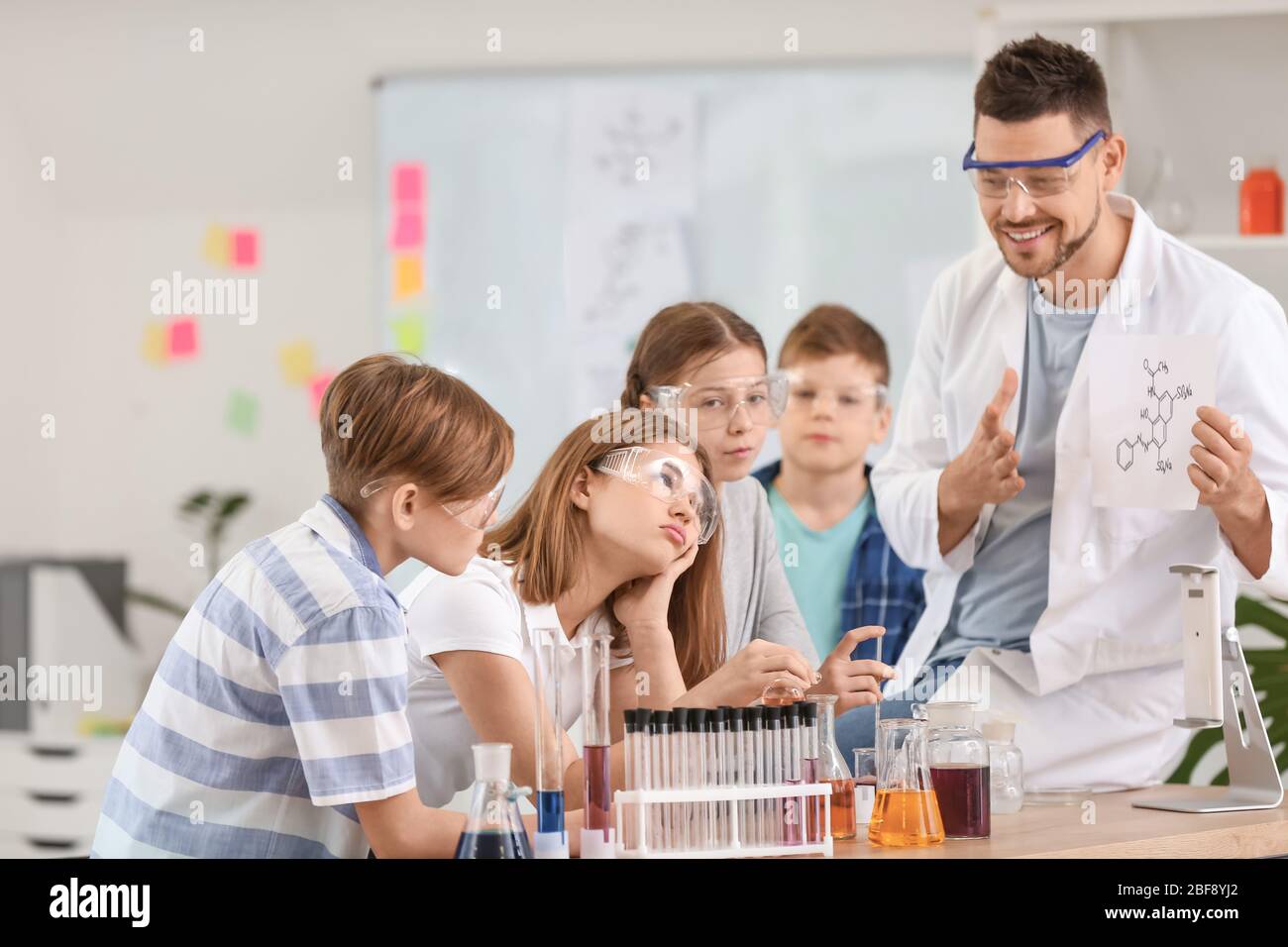 Teacher conducting chemistry lesson in classroom Stock Photo - Alamy