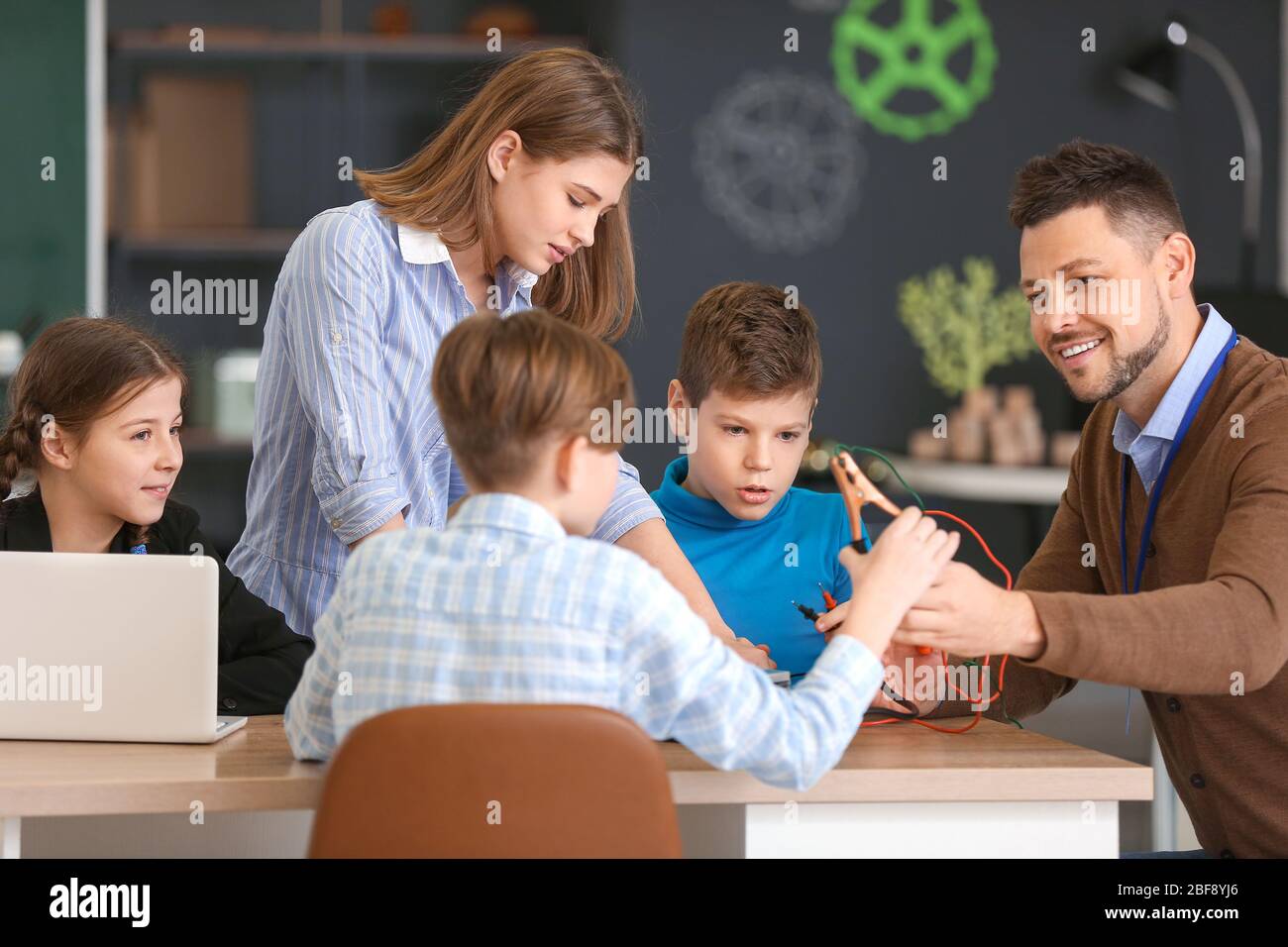 Teacher conducting physics lesson in classroom Stock Photo - Alamy