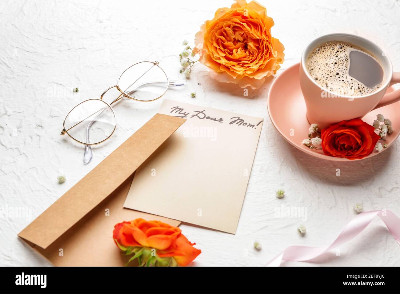 Composition with empty greeting card, envelope and cup of coffee on ...