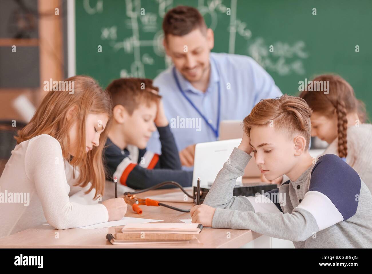 Teacher conducting physics lesson in classroom Stock Photo - Alamy