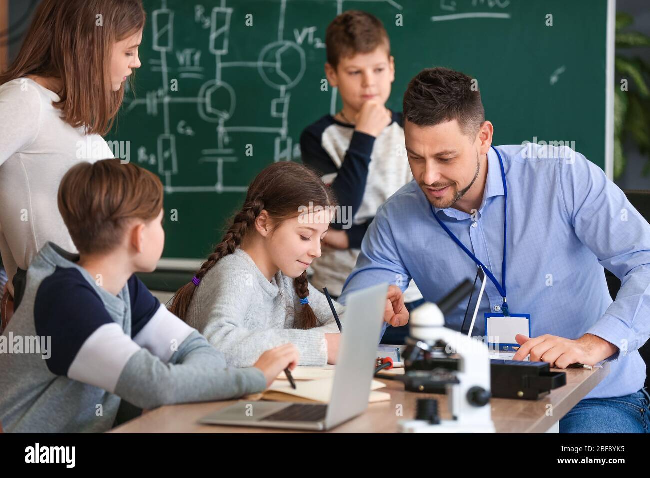 Teacher conducting physics lesson in classroom Stock Photo - Alamy